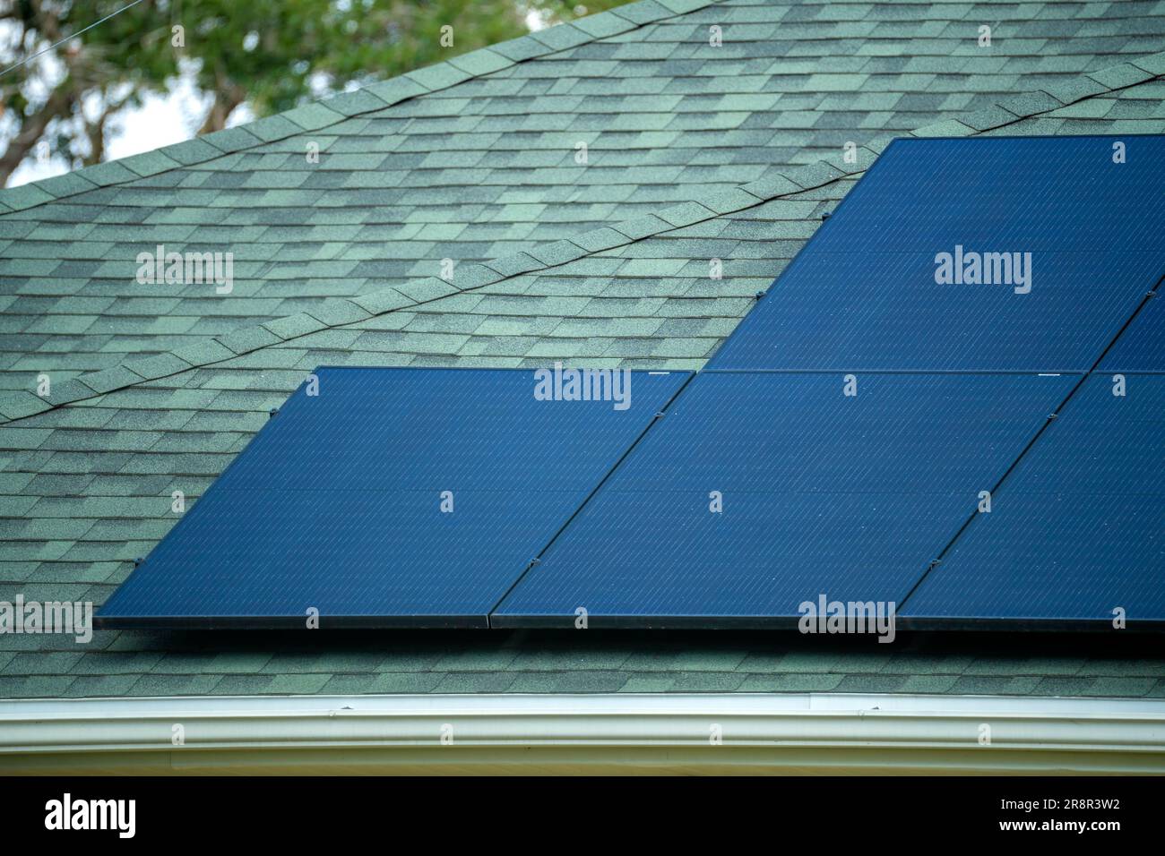 Aerial view building roof with rows of blue solar photovoltaic panels ...