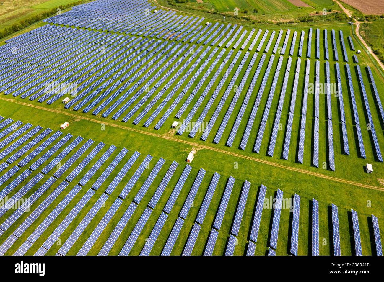 Aerial view of big sustainable electric power plant with many rows of ...