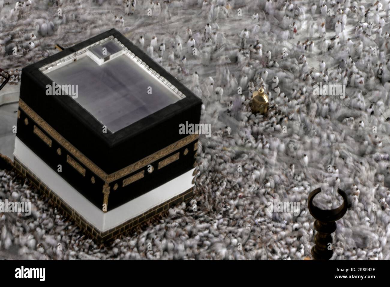 Muslim pilgrims circumambulate around the Kaaba, the cubic building at ...