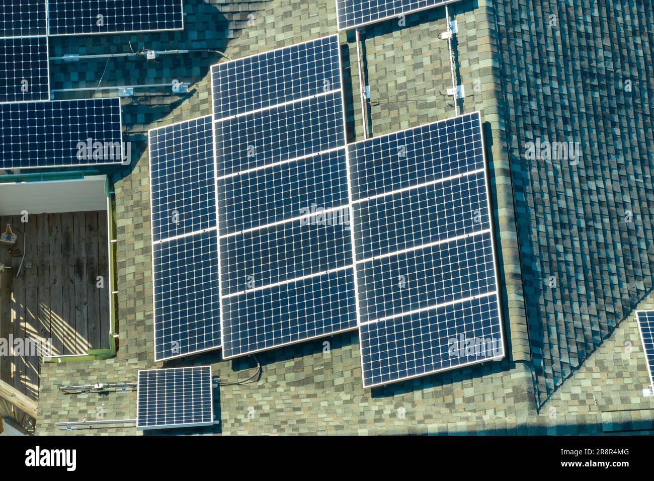 Aerial view of regular american home roof with blue solar photovoltaic ...