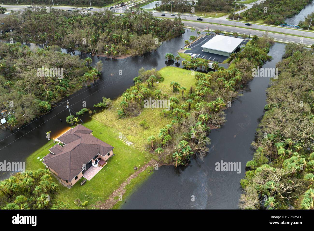 Aftermath of natural disaster. Flooded houses by hurricane Ian rainfall ...