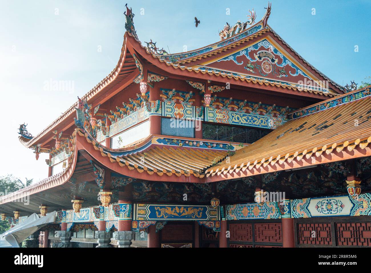 A large and ornately decorated Chinese building in tones of bright ...