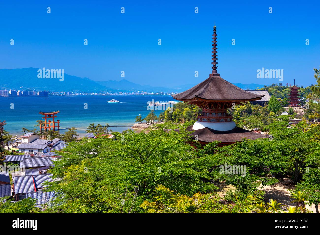 Two story pagoda and the big Torii gate of Itsukushima shrine Stock ...