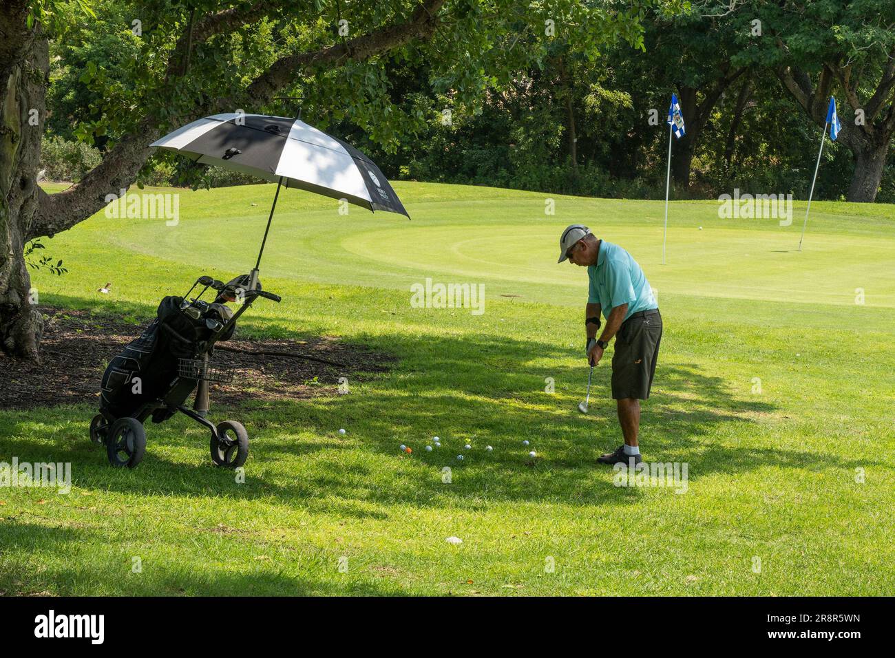 Caesarea, Israel - August 4th, 2022: A man practicing his golf on the ...