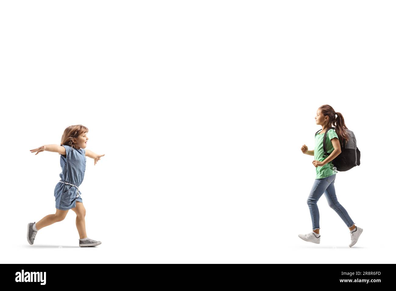 Little girl running to hug a her older sister isolated on white ...