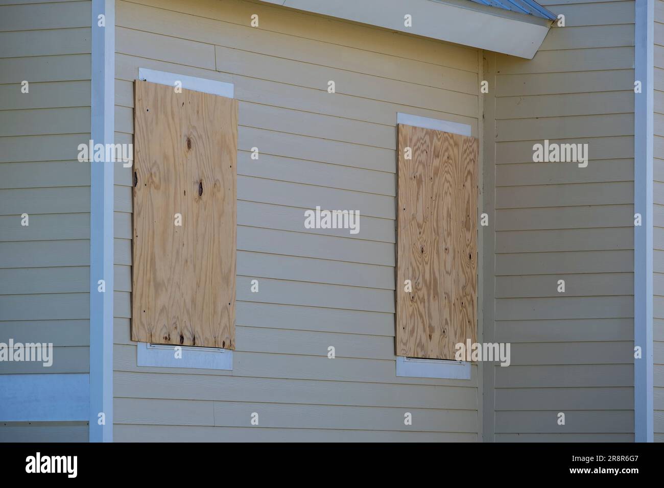 Hurricane shutters made from plywood mounted for protection of house ...
