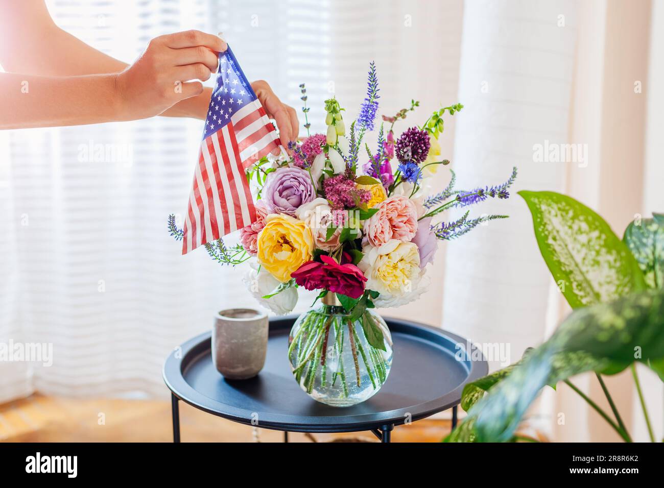 Independence Day Of Usa Woman Puts American Flag In Vase With Flowers