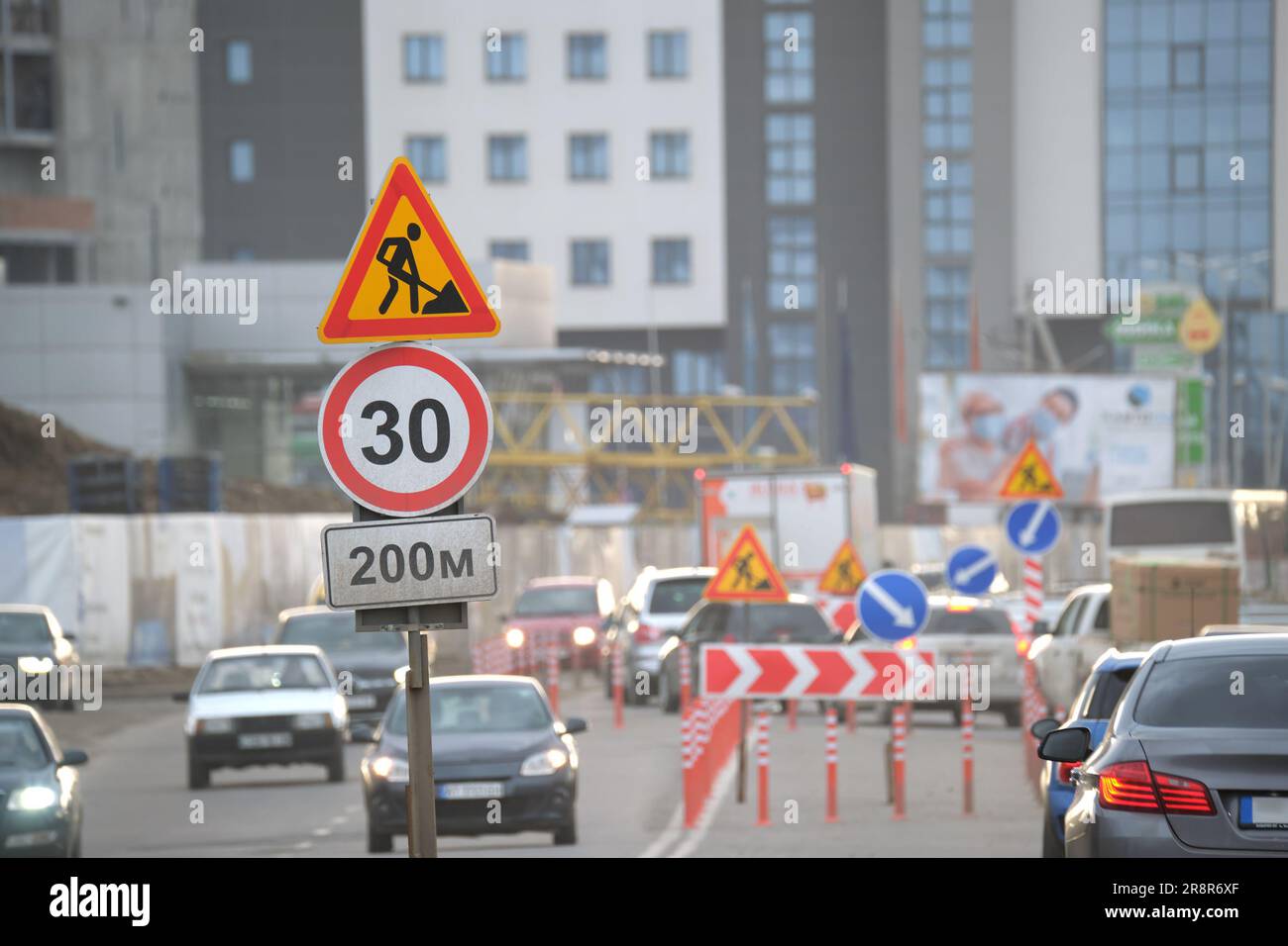 Roadworks warning traffic signs of construction work on city street and ...