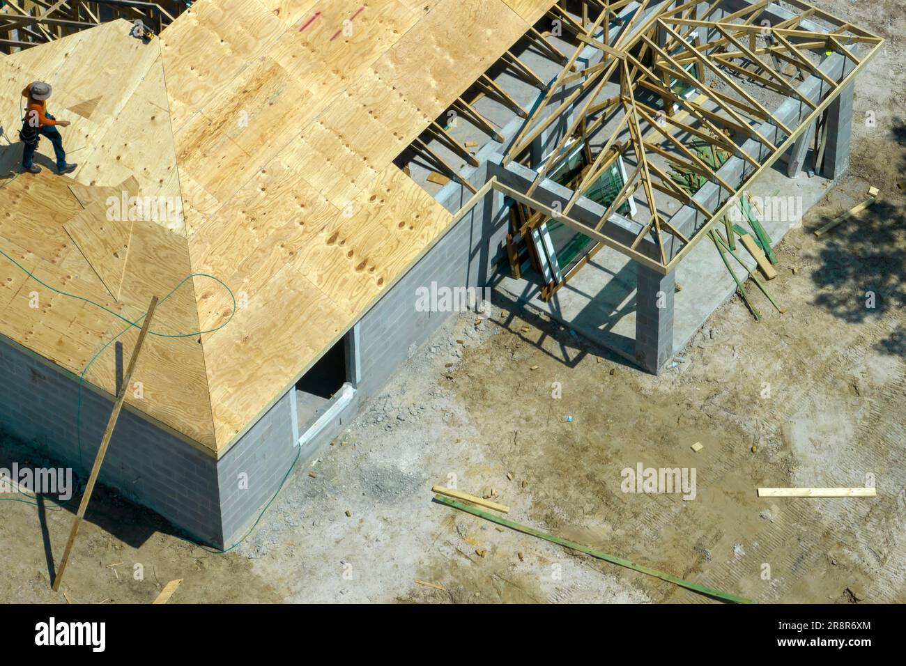 Professional builders working on roof construction of unfinished ...