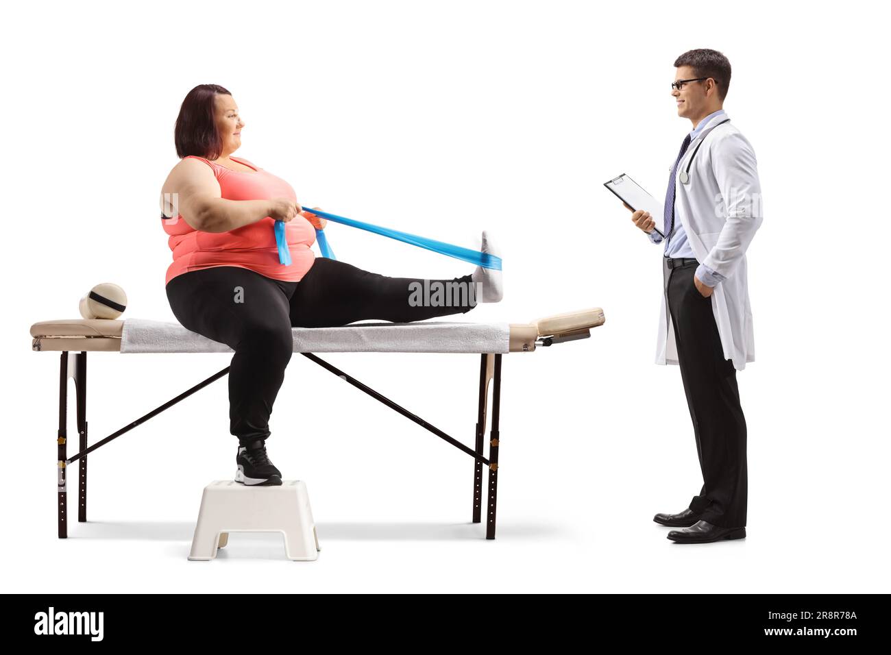 Overweight woman exercising with a stretching band and doctor standing ...
