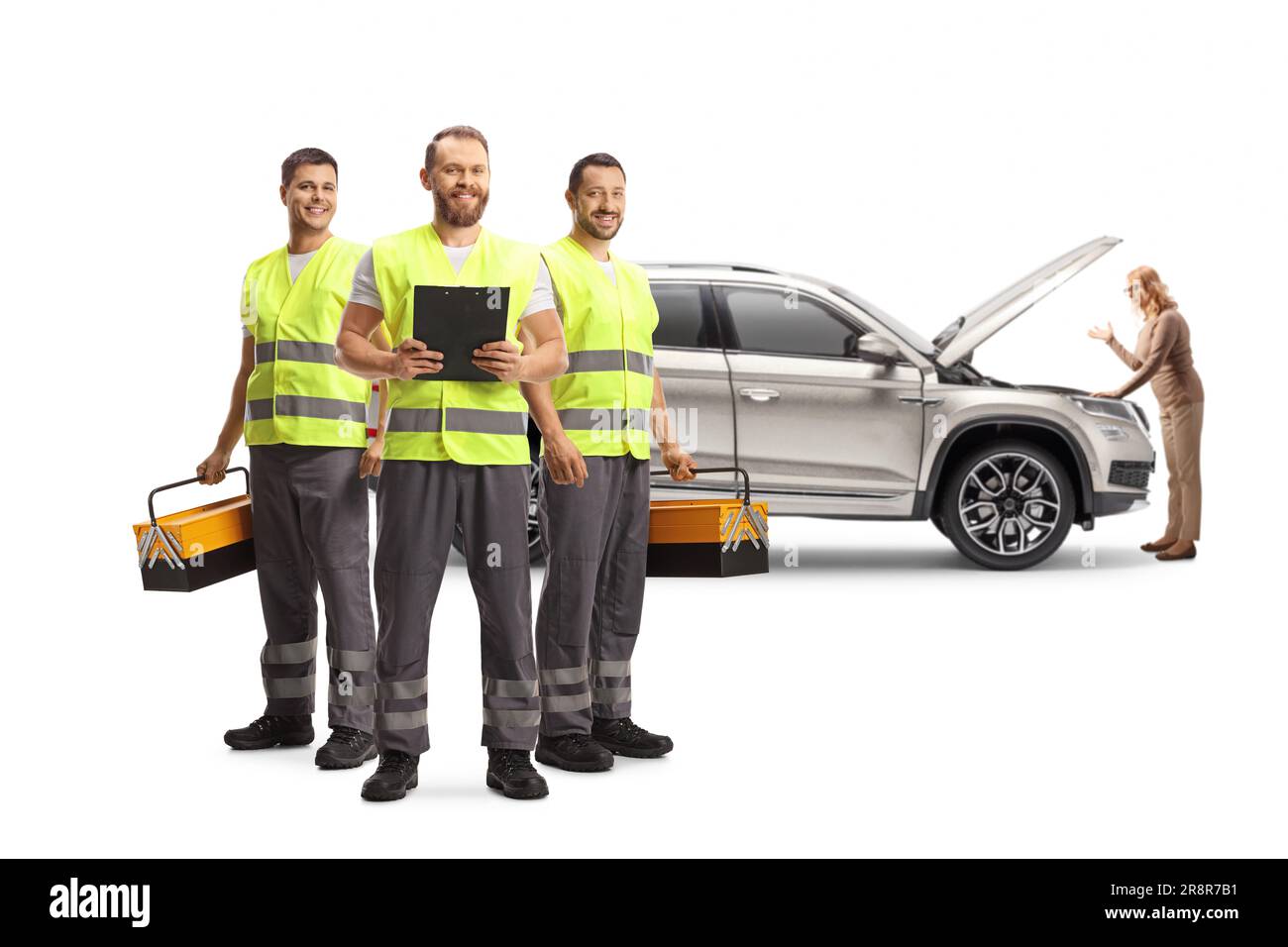 Team of road assistance workers with reflective vests standing in front ...