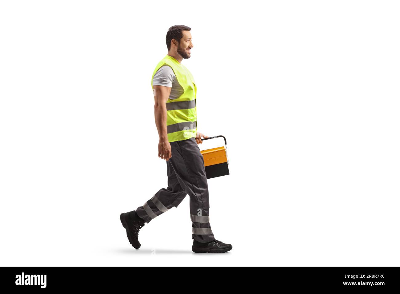 Road assistance mechanic walking and carrying a tool box isolated on ...