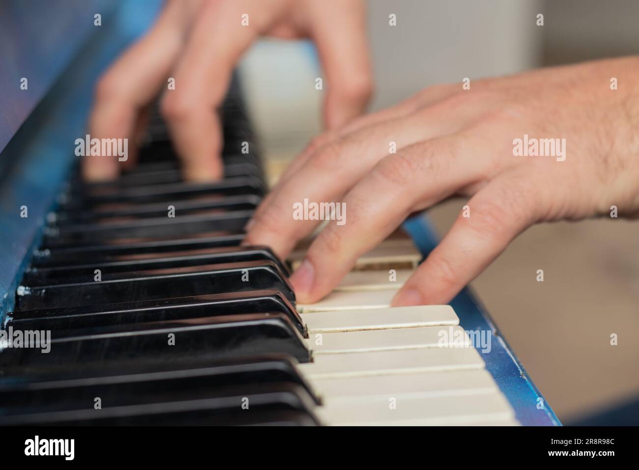 male hands on the piano close up, musical instrument Stock Photo - Alamy