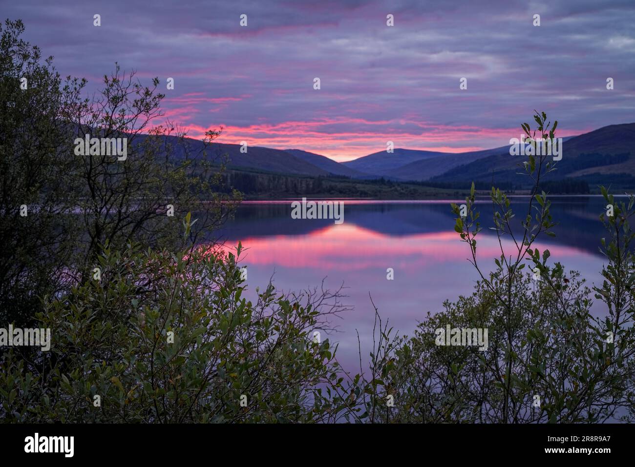 sunset looking over loch in galloway forest scotland Stock Photo - Alamy