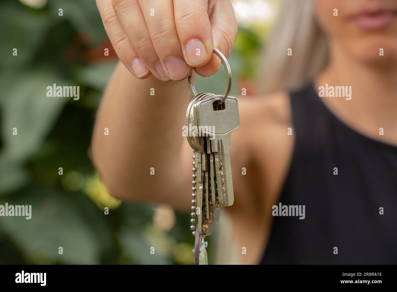 a bunch of keys from the apartment is held by the girl's hand close-up ...