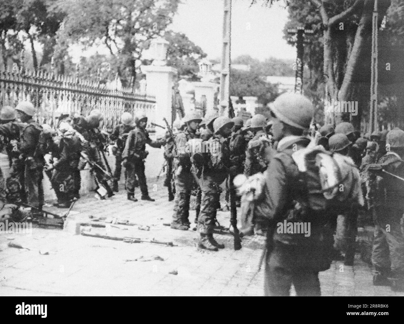Rebel troops stand outside the fence-enclosed presidential palace in ...