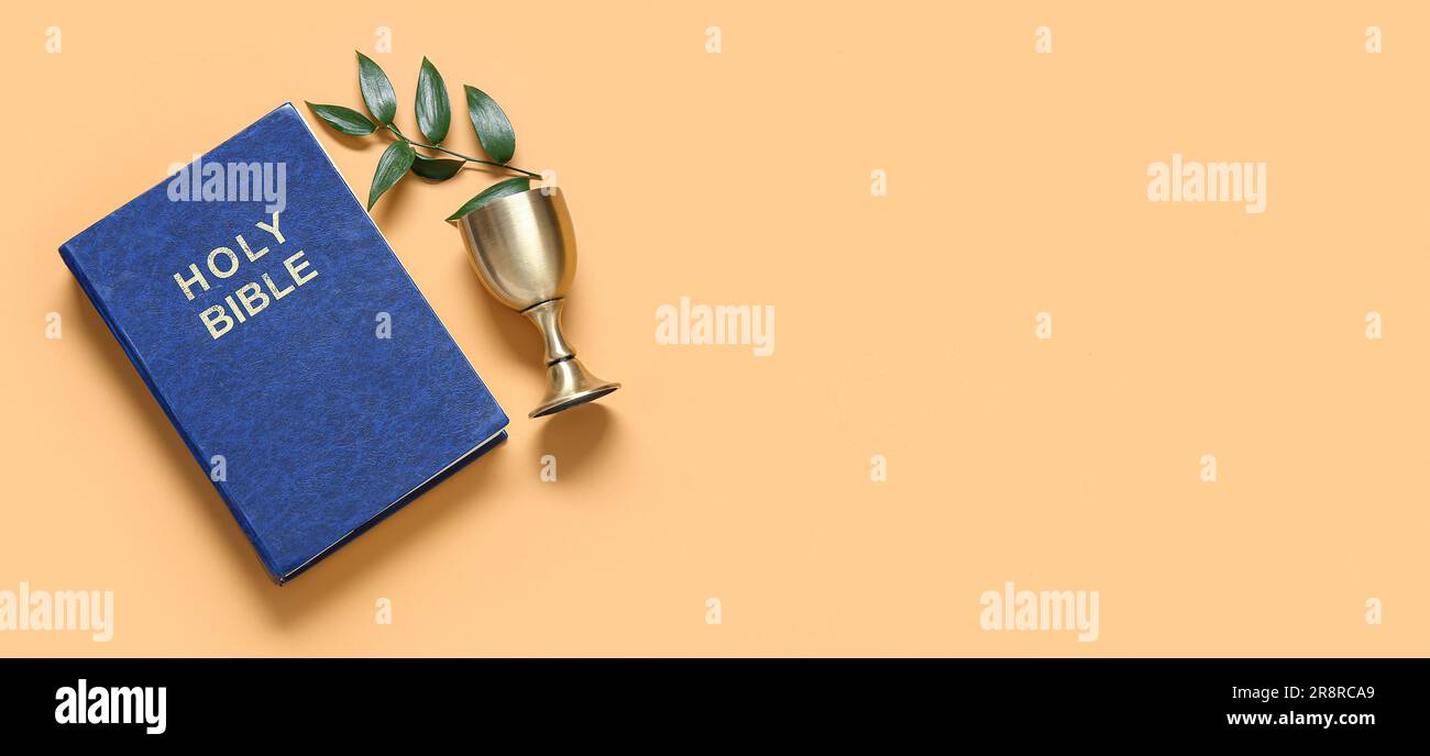 Holy Bible and chalice on beige background with space for text Stock ...