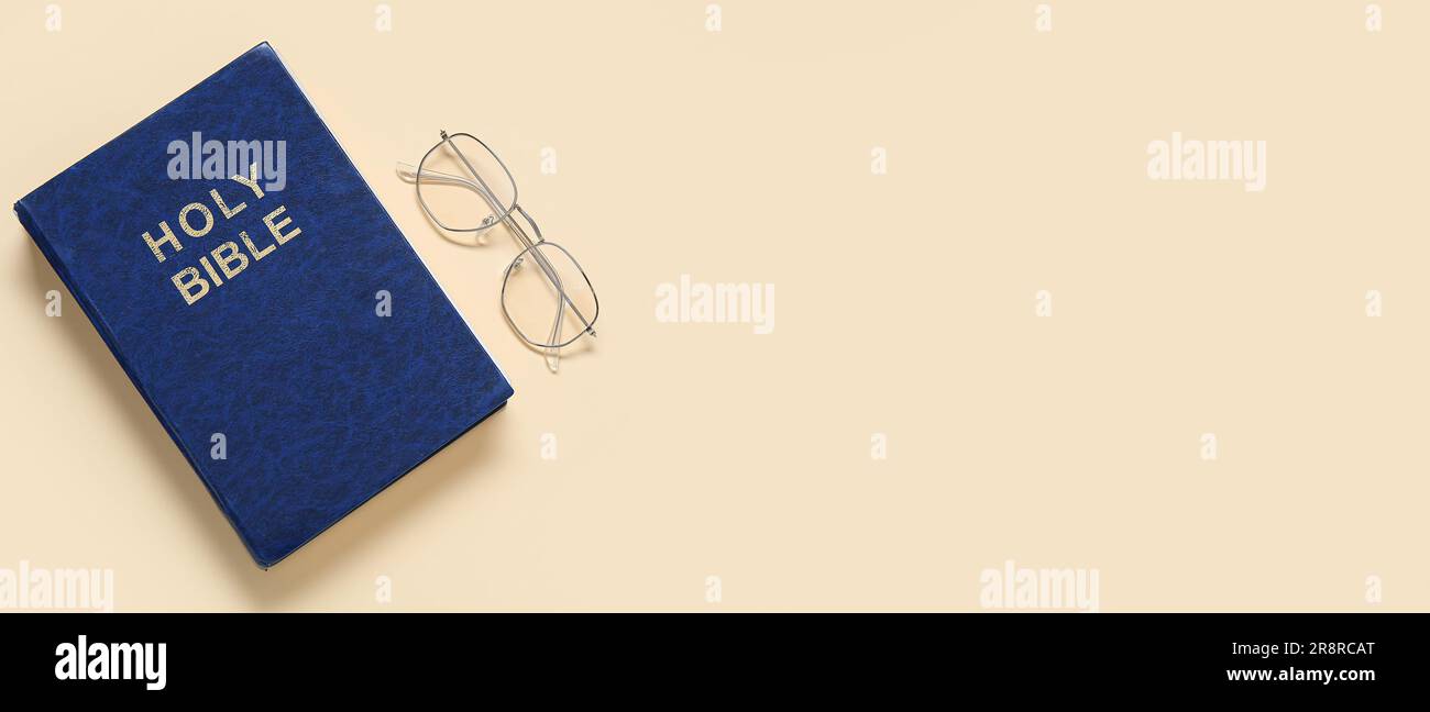 Holy Bible and glasses on beige background with space for text Stock ...