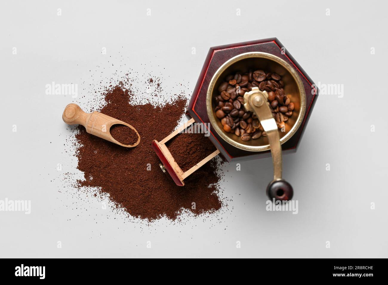 Coffee grinder with powder and scoop on white background Stock Photo ...