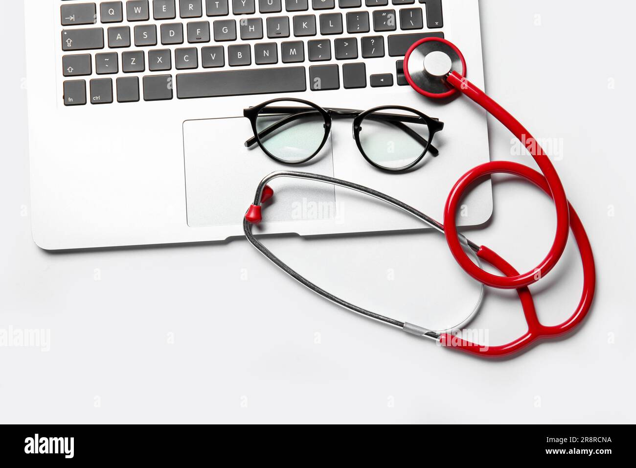 Stethoscope, laptop and glasses on white background Stock Photo - Alamy