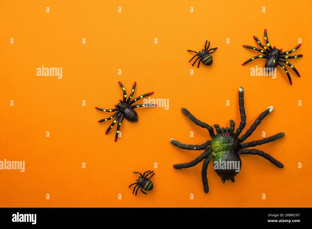 Group of black toy spiders on a orange background for halloween Stock ...