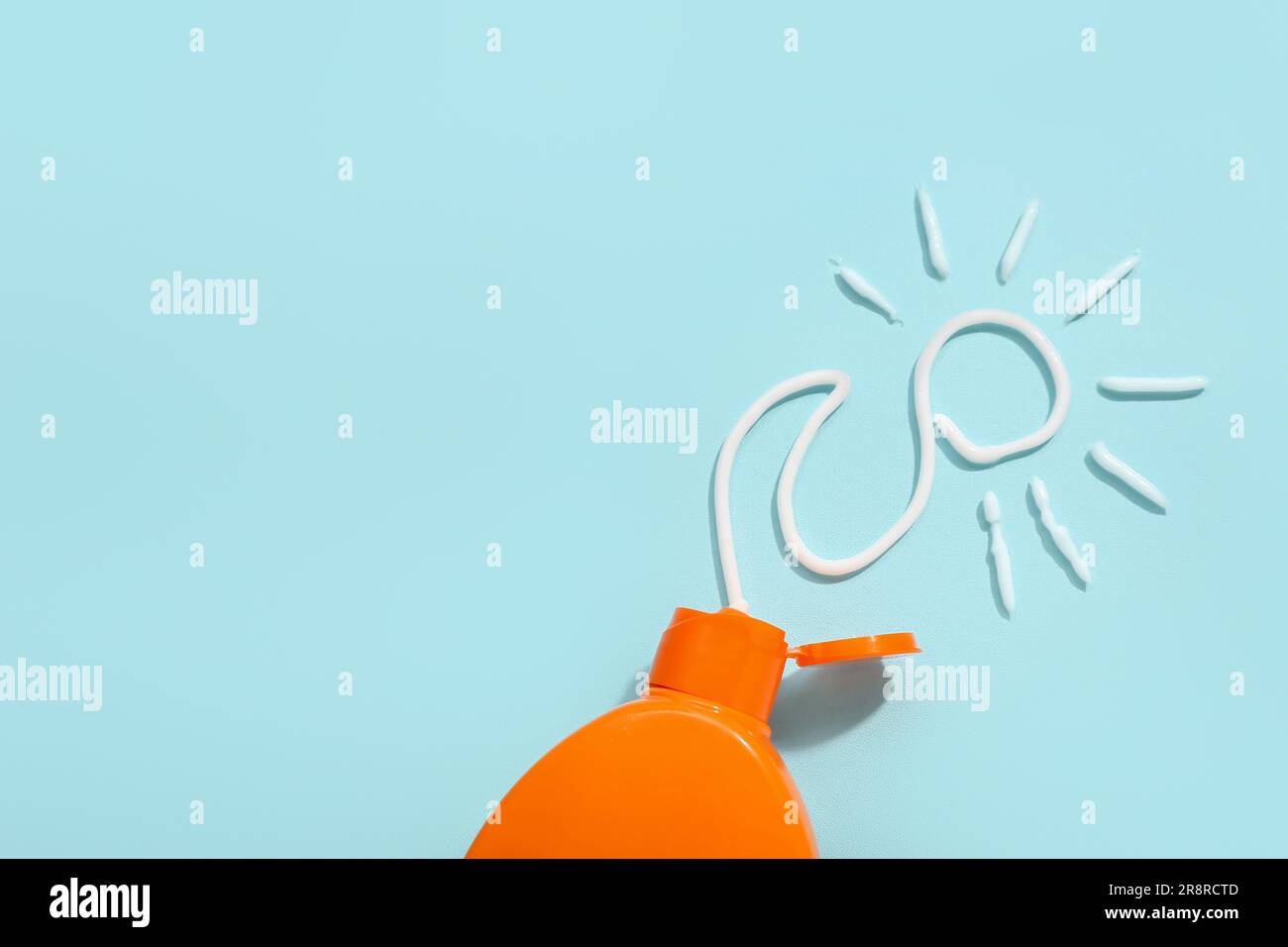 Drawings of sun made with sunscreen cream on pale blue background Stock ...