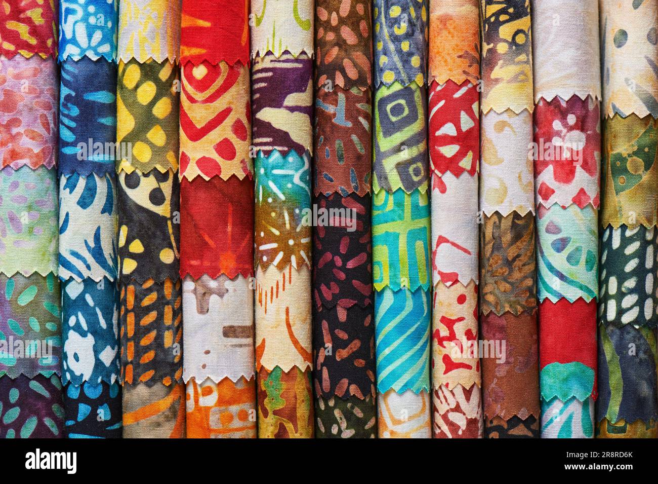 Stack of colorful quilting batik fabrics as a vibrant background image ...