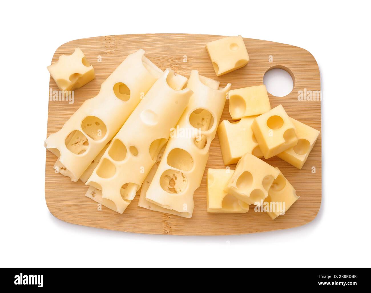 Cubes and slices of Swiss cheese with wooden board on white background ...