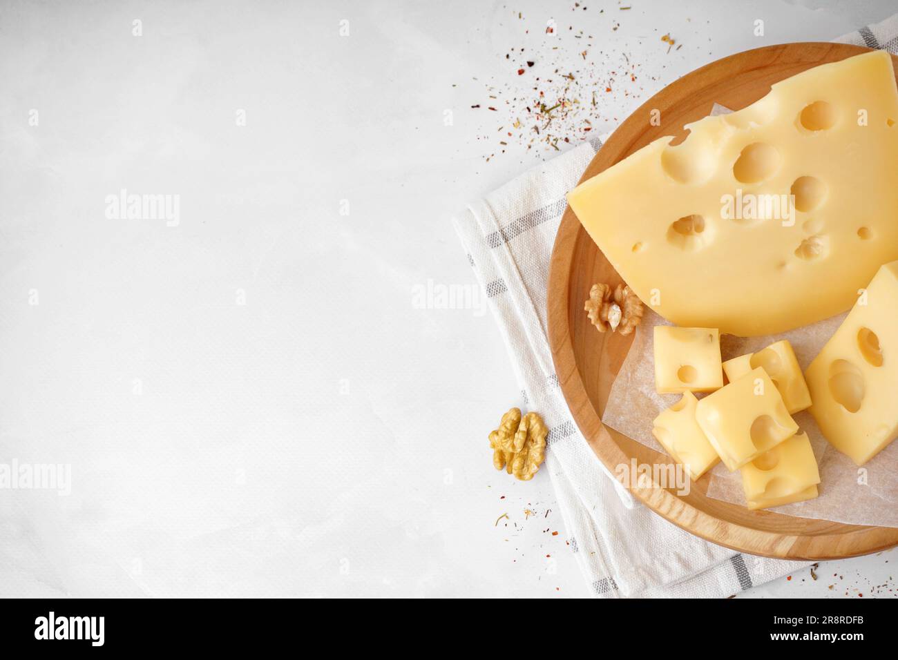 Plate with pieces of Swiss cheese and walnut on white background Stock ...