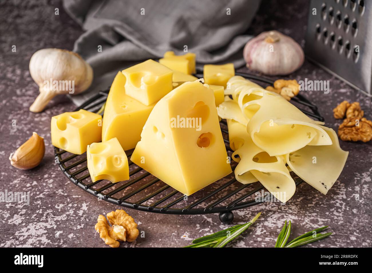 Stand with pieces of Swiss cheese and walnut on grey background Stock ...