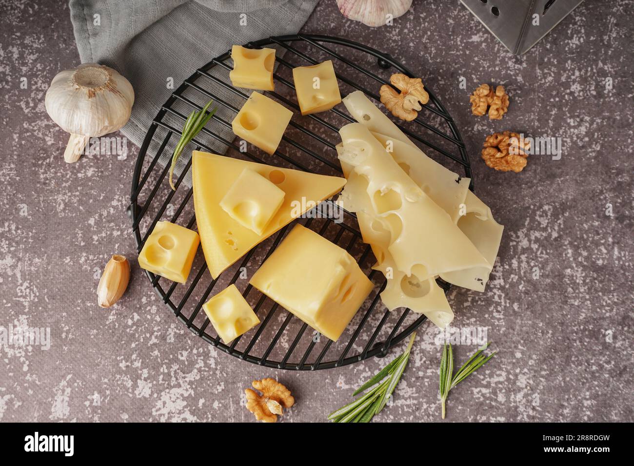 Stand with pieces of Swiss cheese and walnut on grey background Stock ...