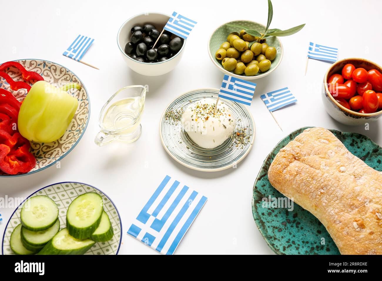Plates with different food and flags of Greece on white background ...