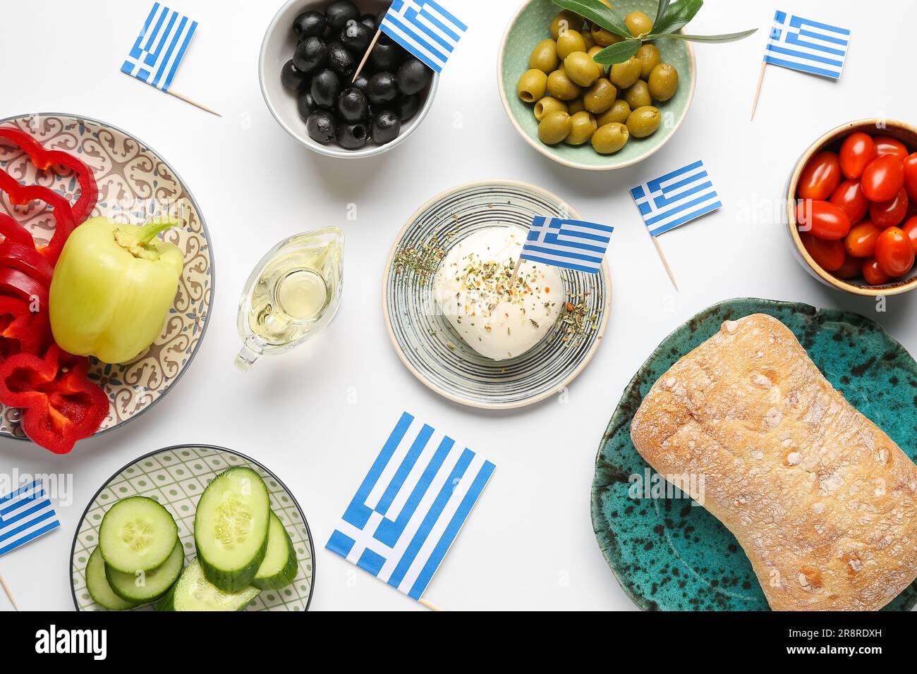 Plates with different food and flags of Greece on white background ...