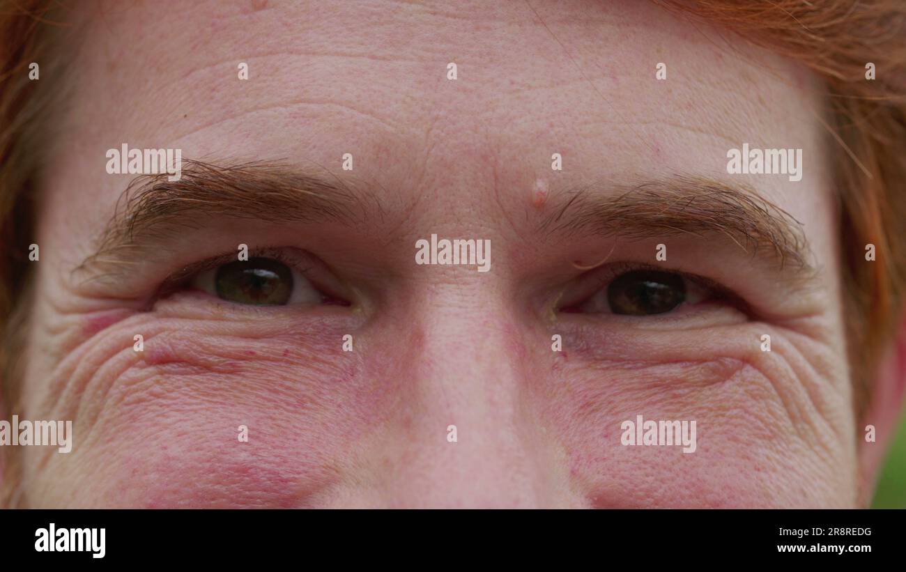 Man with serious judgemental emotion macro close-up eyes. A male person ...