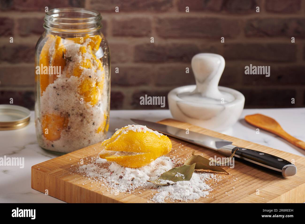 Cutted lemon in mix sea salt and spices, jar with salted lemons and ...