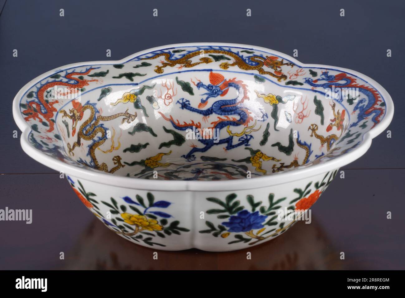 A white ceramic bowl, featuring a decorative design, resting atop a ...