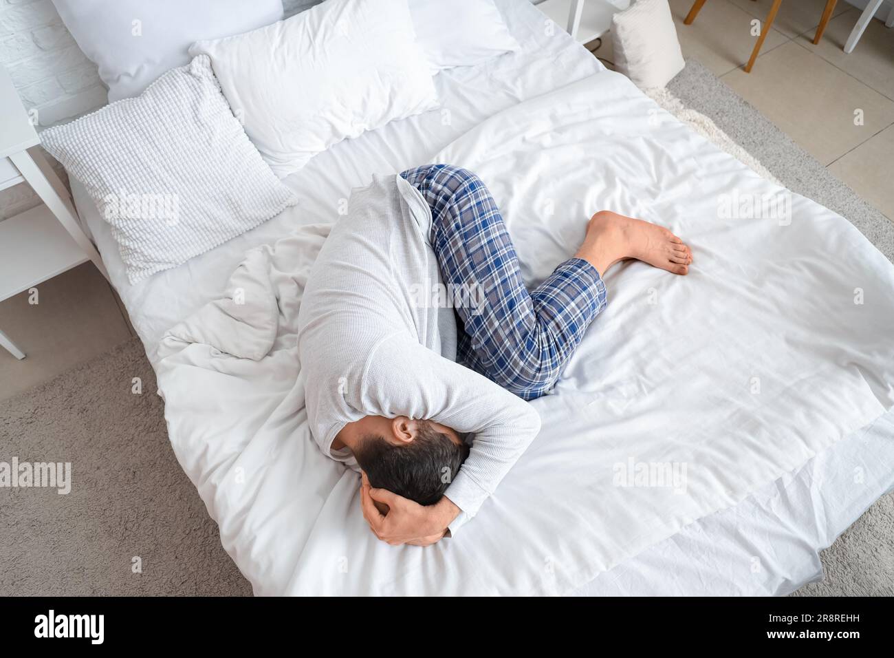 Frightened man lying in bed hi-res stock photography and images - Alamy
