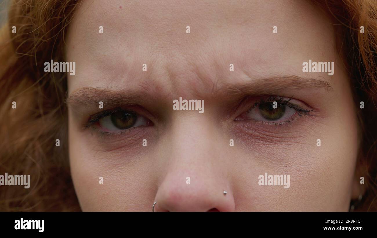 Woman changing emotion, macro close-up eyes looking at camera. A female ...