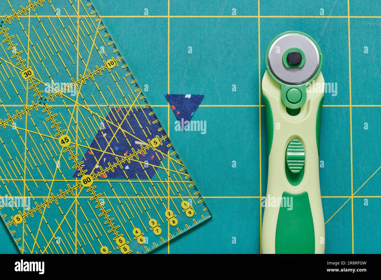 The process of cutting pieces of fabric in the shape of hexagons to ...