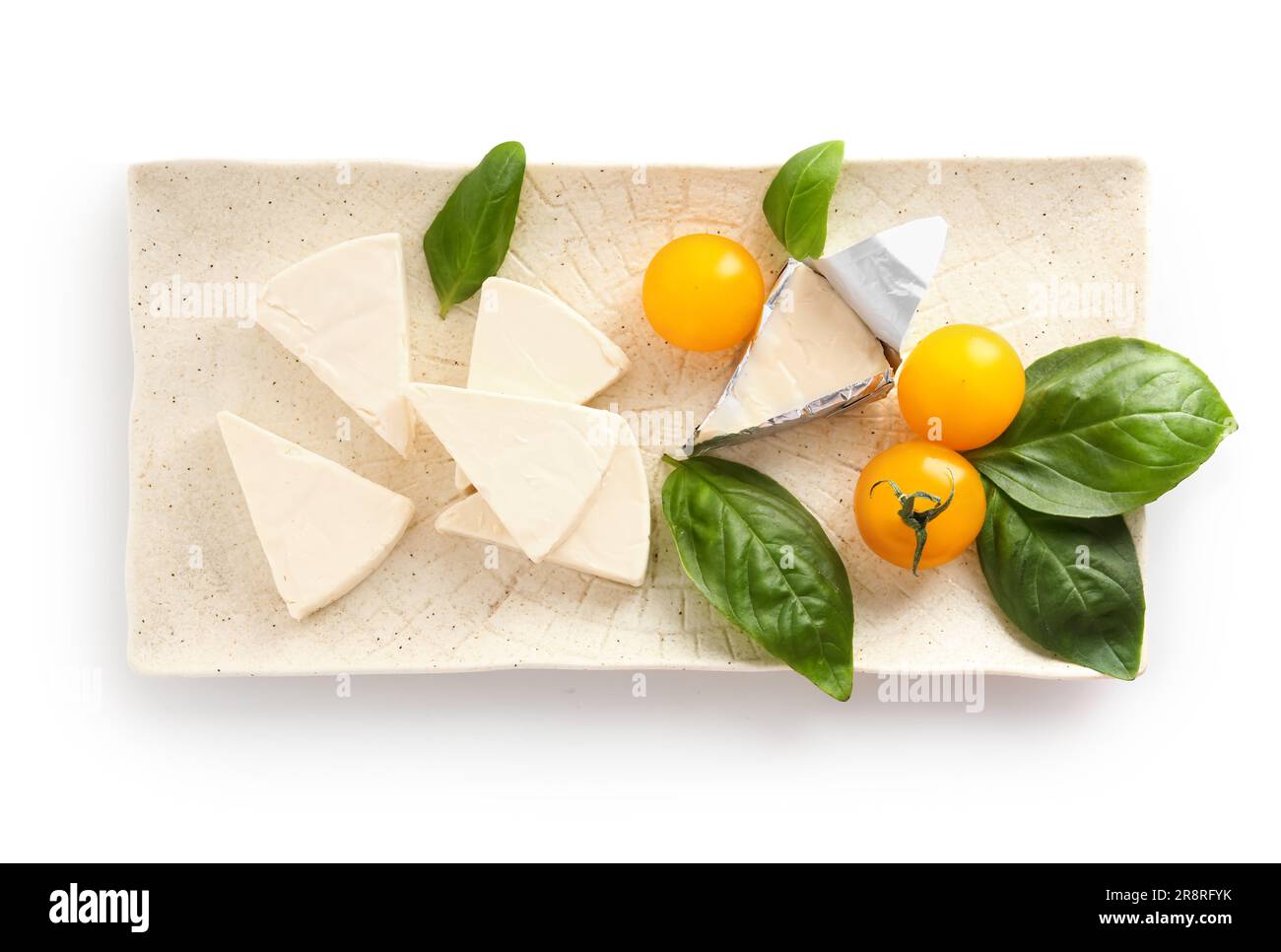 Plate with triangles of tasty processed cheese, cherry tomatoes and ...