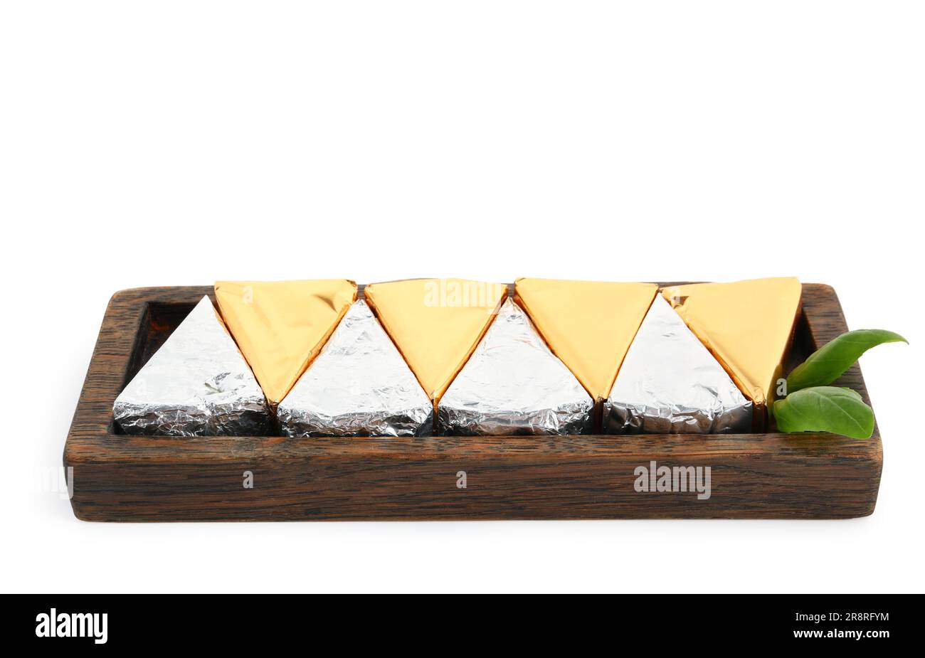 Board with triangles of tasty processed cheese in foil on white ...