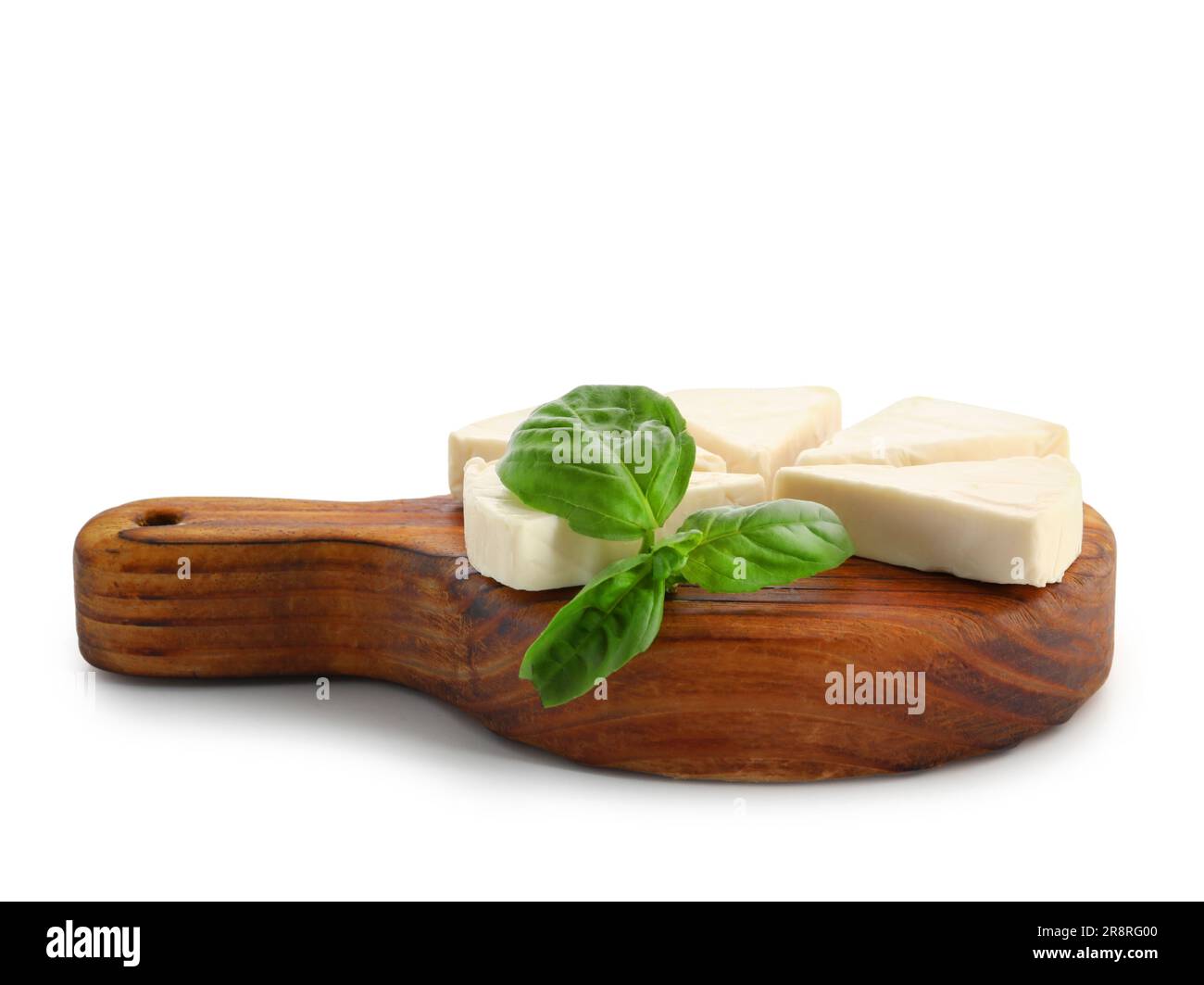 Board with triangles of tasty processed cheese and basil leaves on ...