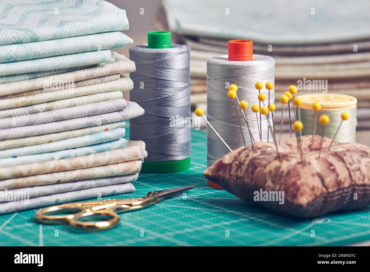 Set of pastel fabrics and sewing tools on craft mat Stock Photo - Alamy