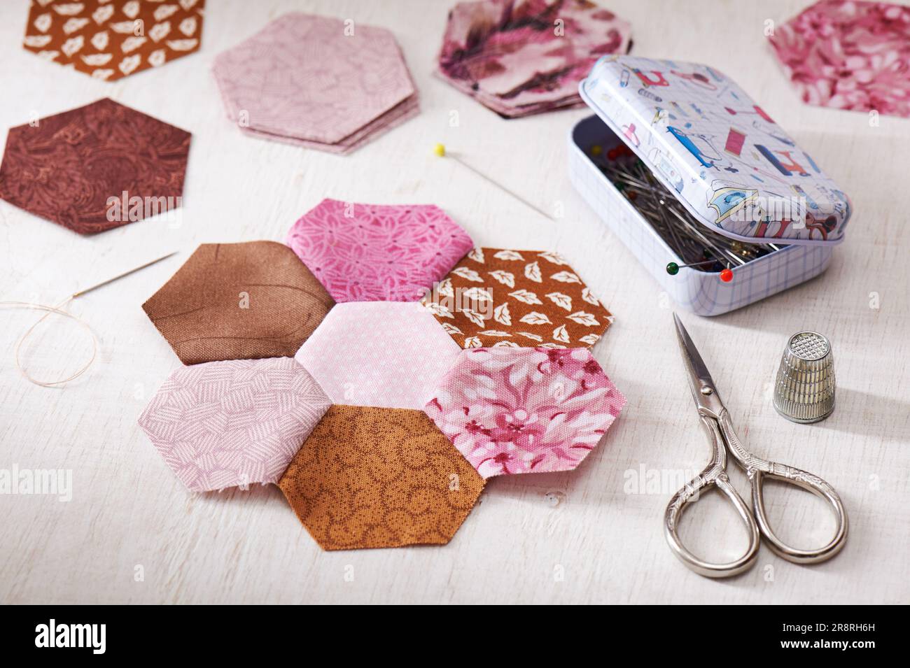 Sewing of hexagon pieces of fabric a quilt Grandmother's Flower Garden ...