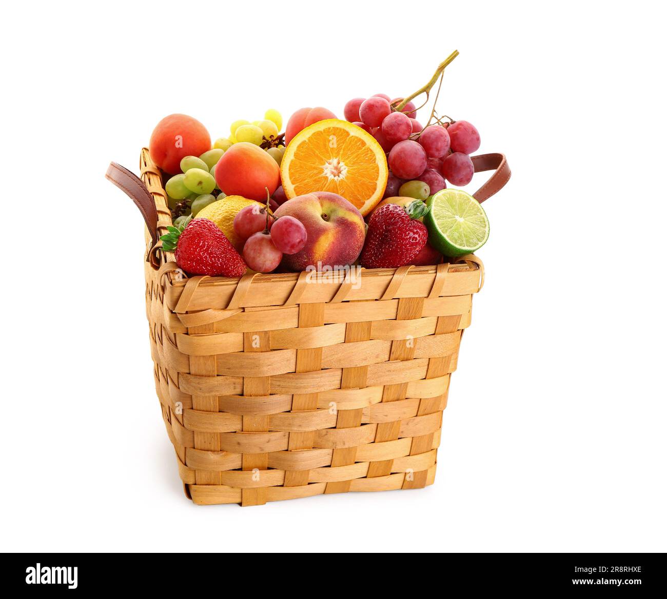 Wicker basket with different fresh fruits on white background Stock ...