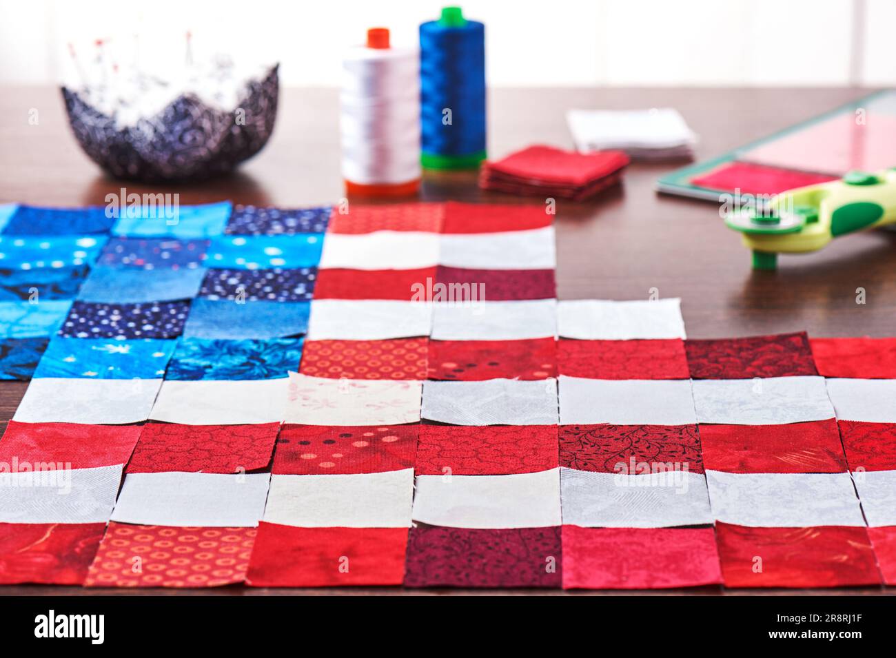 Preparing to sewing of pieces of fabrics that look like a flag of USA ...