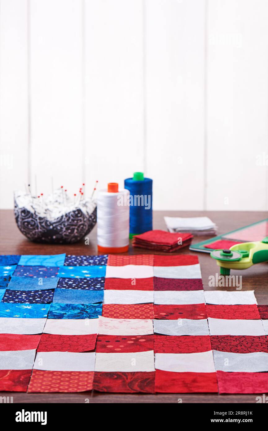 Preparing to sewing of pieces of fabrics that look like a flag of USA ...
