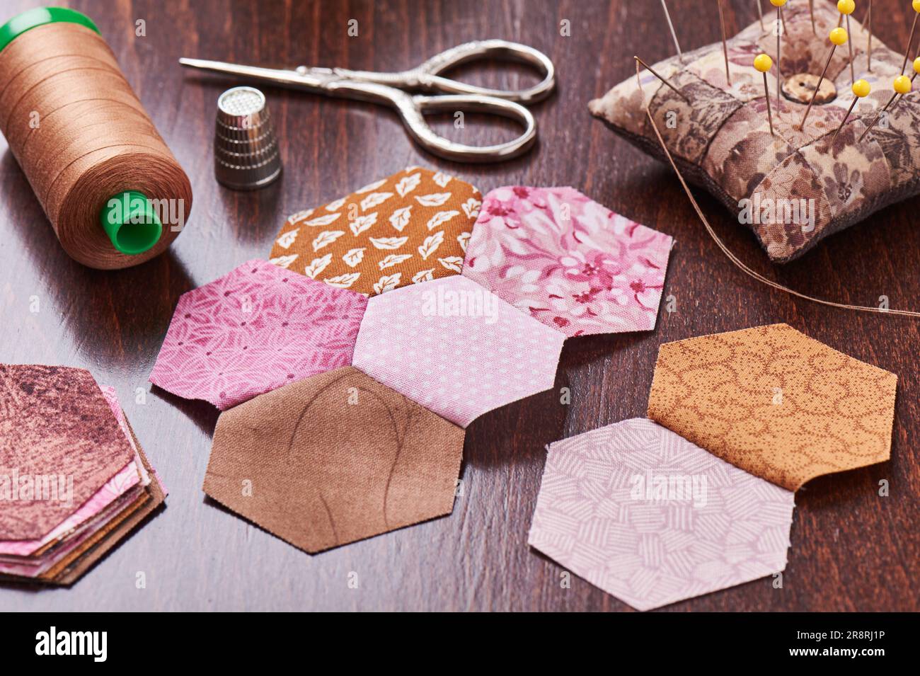 Sewing of hexagon pieces of fabric a quilt Grandmother's Flower Garden ...