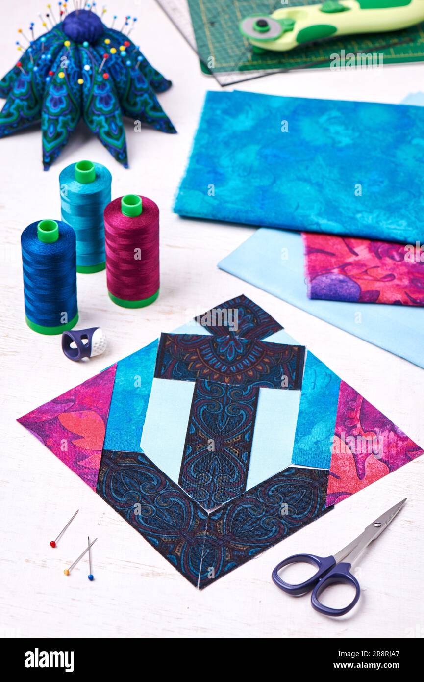 Sewing patchwork of block anchor surrounded by accessories Stock Photo ...