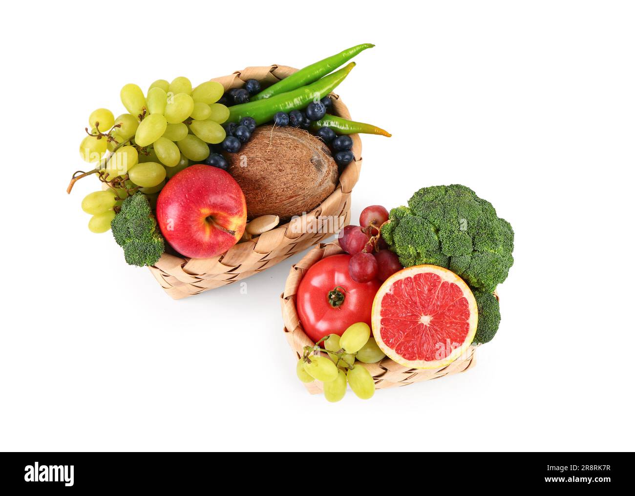 Wicker baskets with different fresh fruits and vegetables on white ...